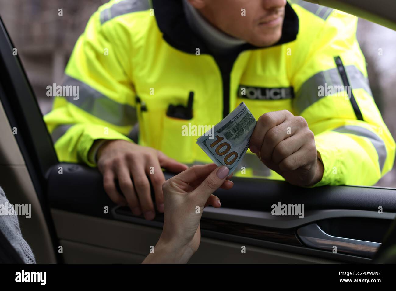 Woman giving bribe to police officer out of car window, closeup Stock ...