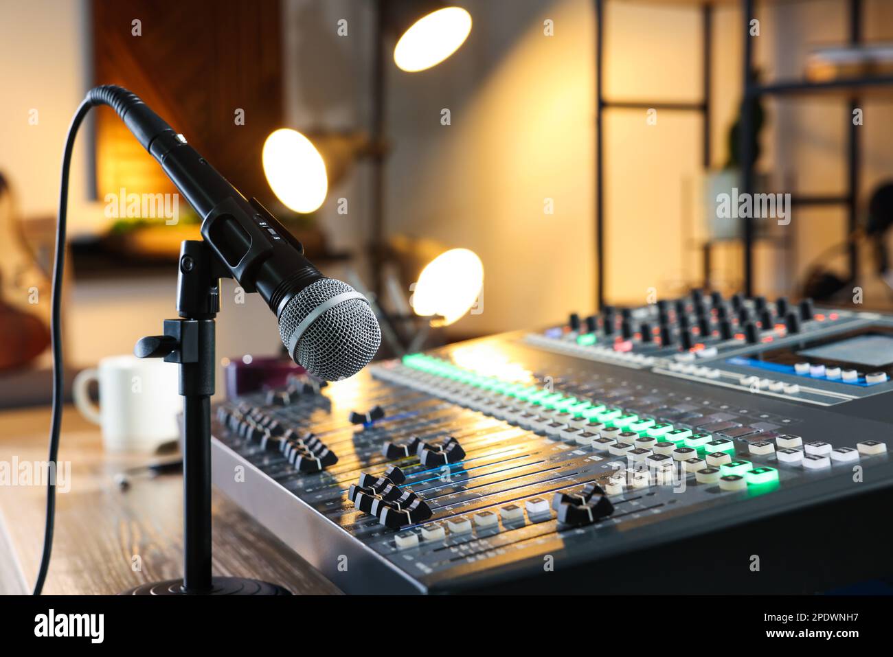 Microphone and professional mixing console on table in radio studio ...