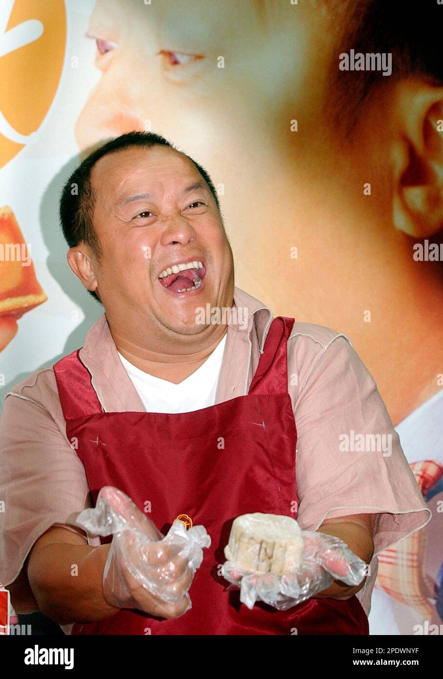 Hong Kong actor Eric Tsang tries his hands at making mooncakes at a ...