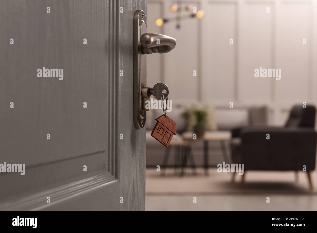 Closeup view of open door with key in room Stock Photo - Alamy