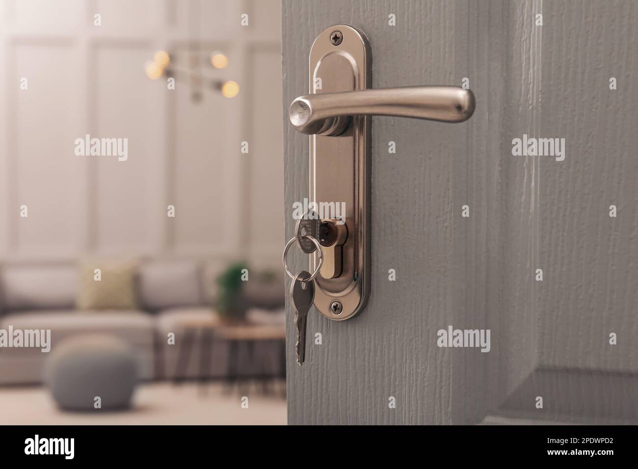 Closeup view of open door with key in room Stock Photo - Alamy