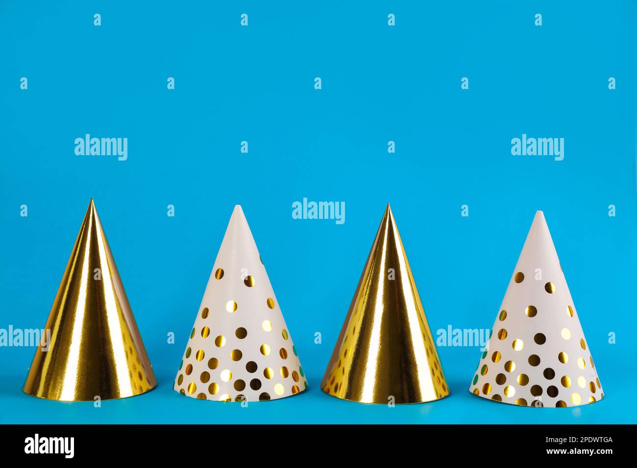 Colorful party hats on light blue background Stock Photo - Alamy