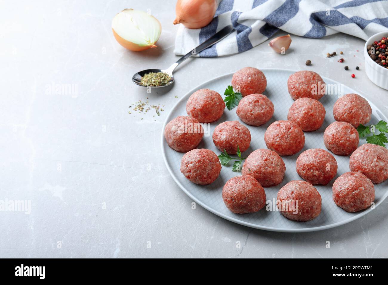 Many fresh raw meatballs on light table, space for text Stock Photo - Alamy
