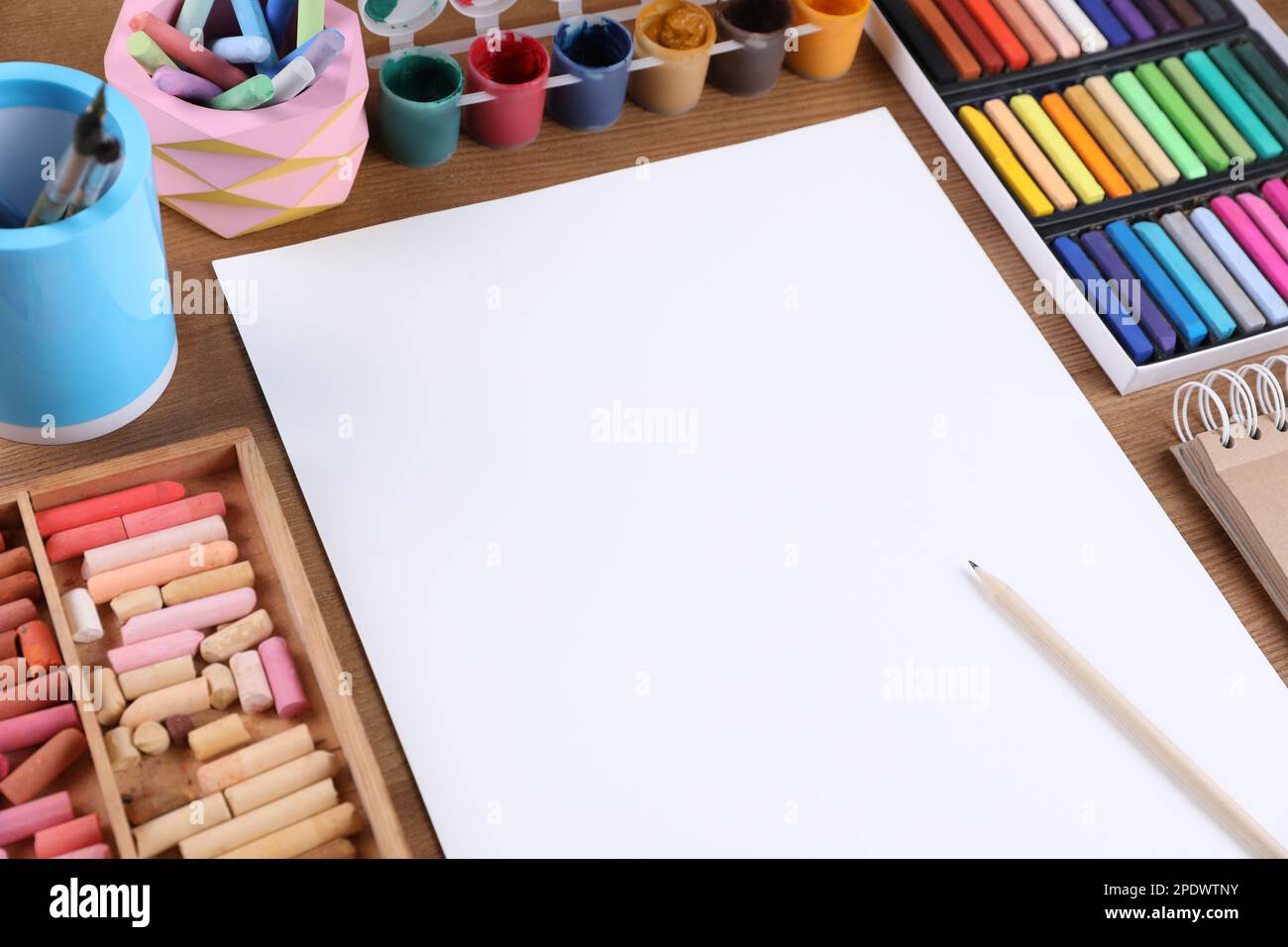 Blank sheet of paper, colorful chalk pastels and other drawing tools on ...