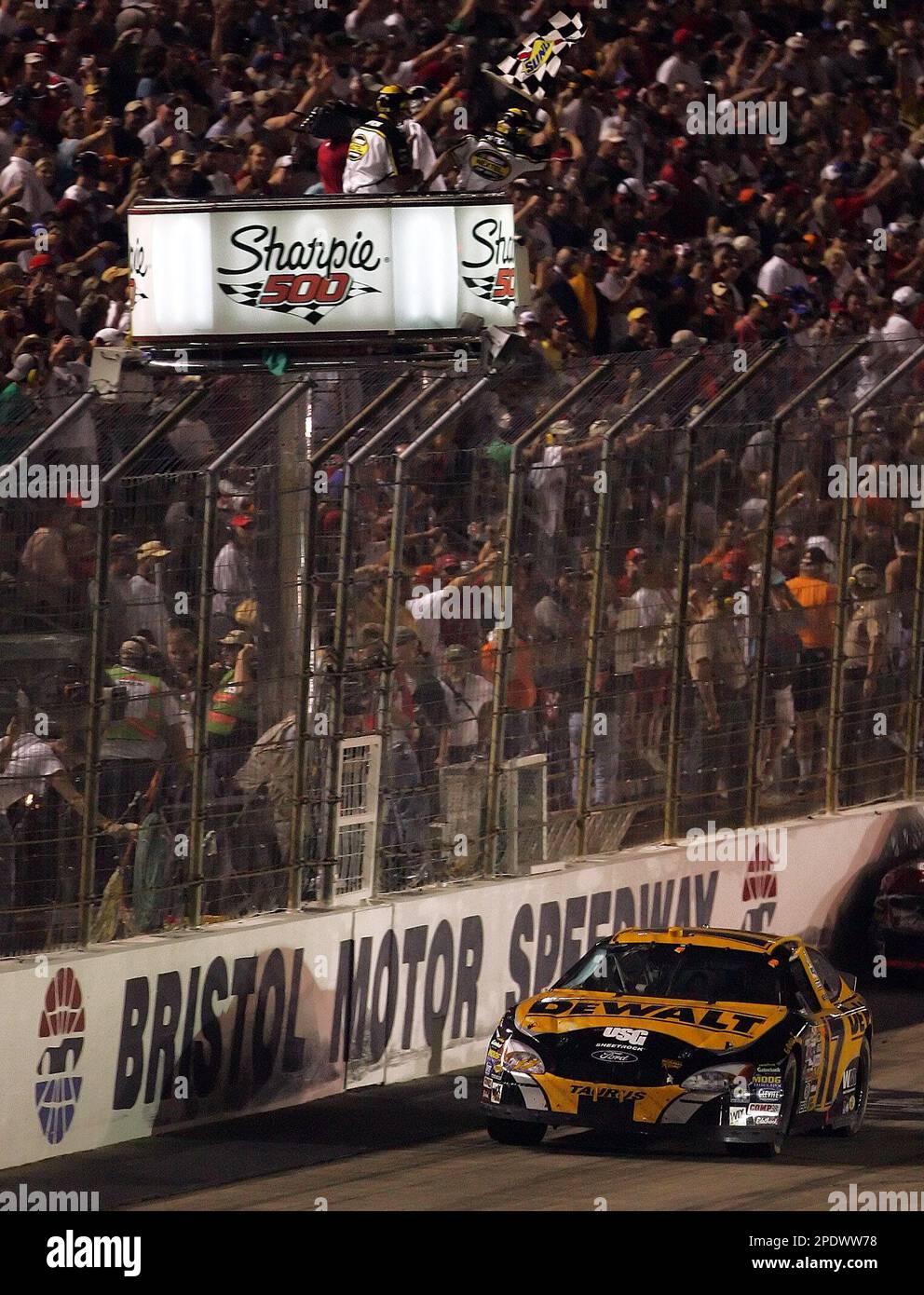 Matt Kenseth gets the checkered flag as he crosses the finish line to ...