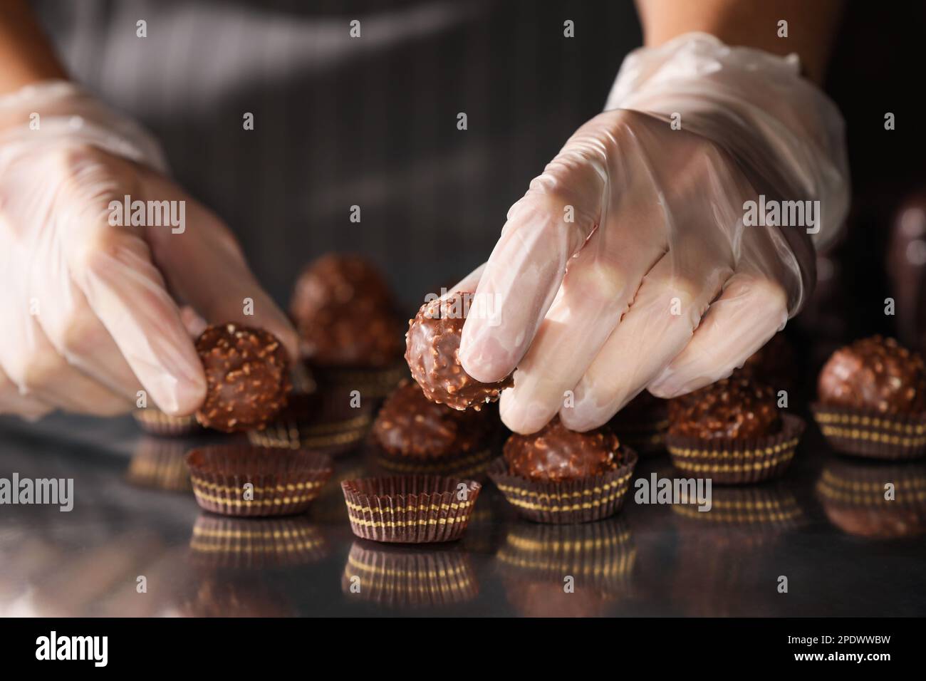 Woman packing delicious candies at production line, closeup Stock Photo ...