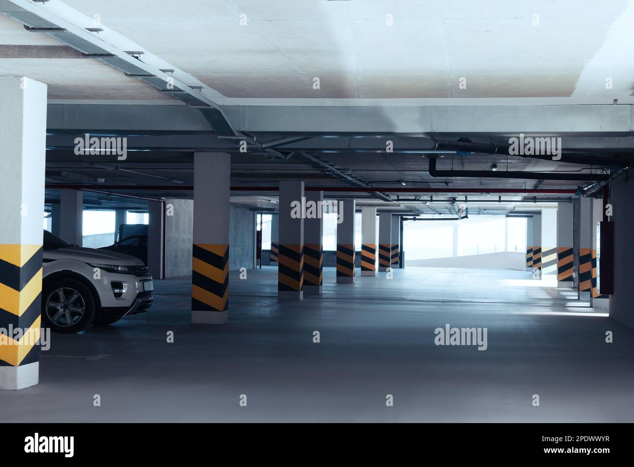 Open parking garage with car on sunny day Stock Photo - Alamy