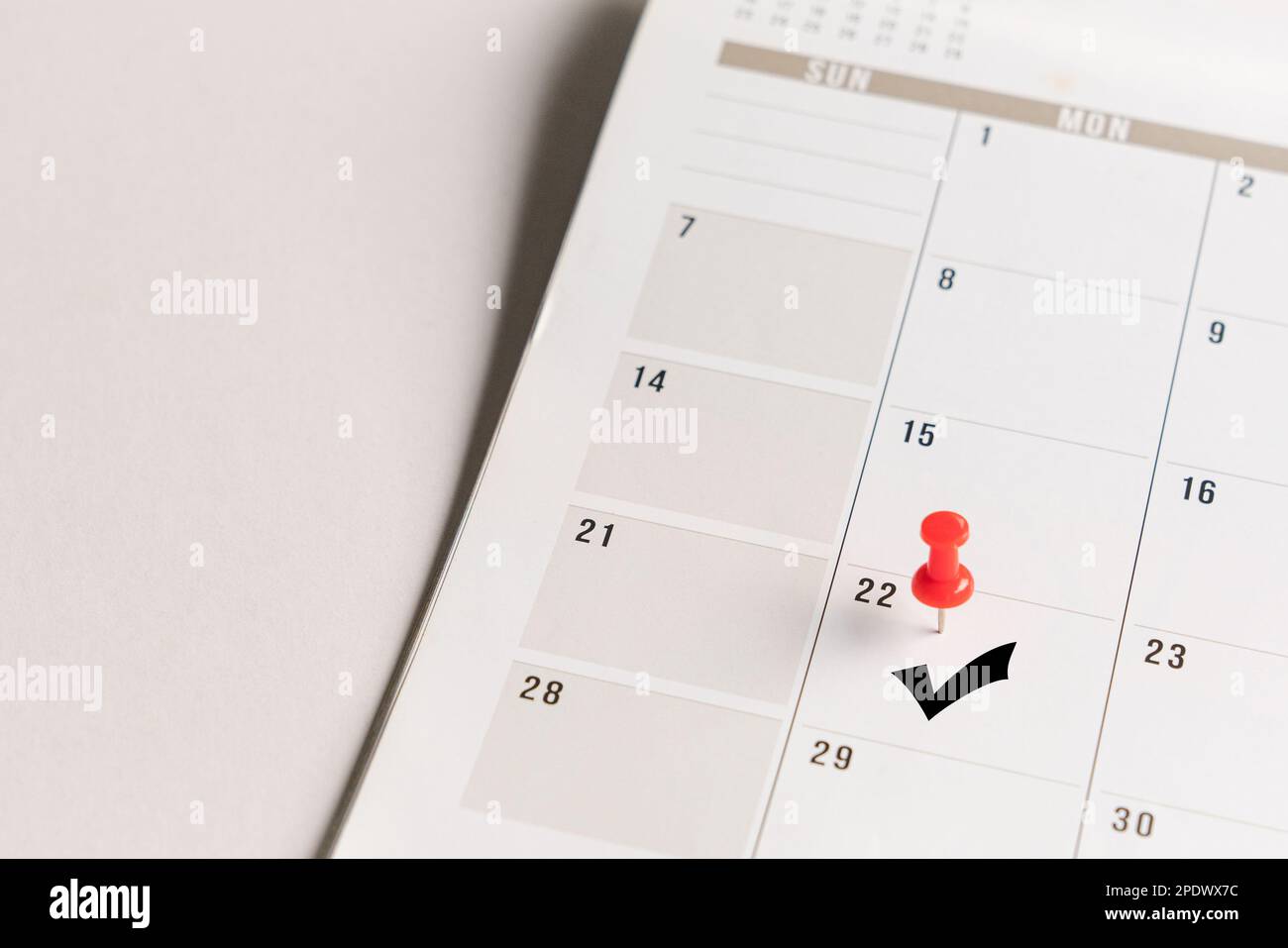 Red pin and arrow symbol on calendar. Confirmation of appointment or ...