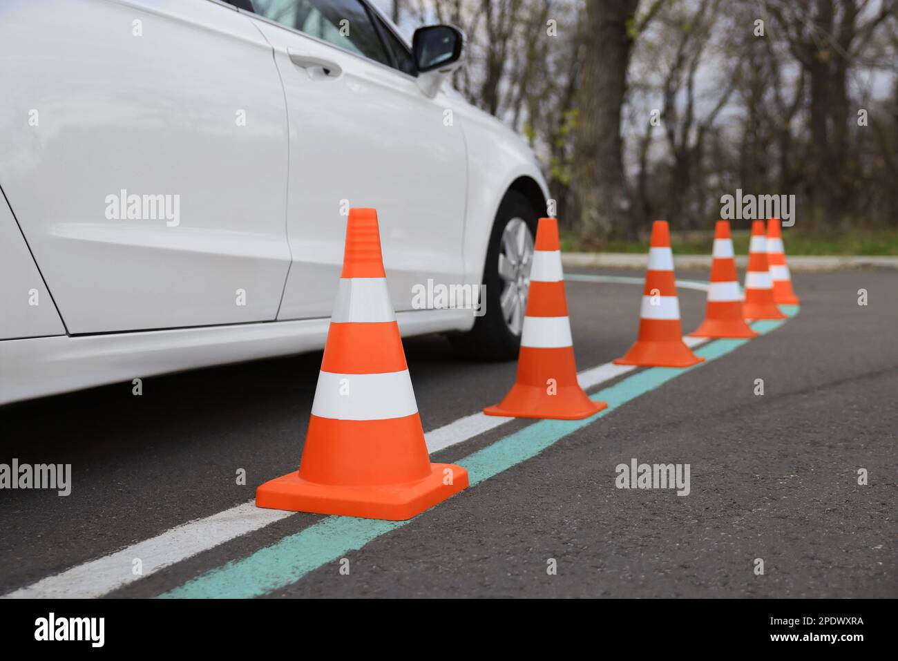 Modern car on test track with traffic cones, closeup. Driving school ...