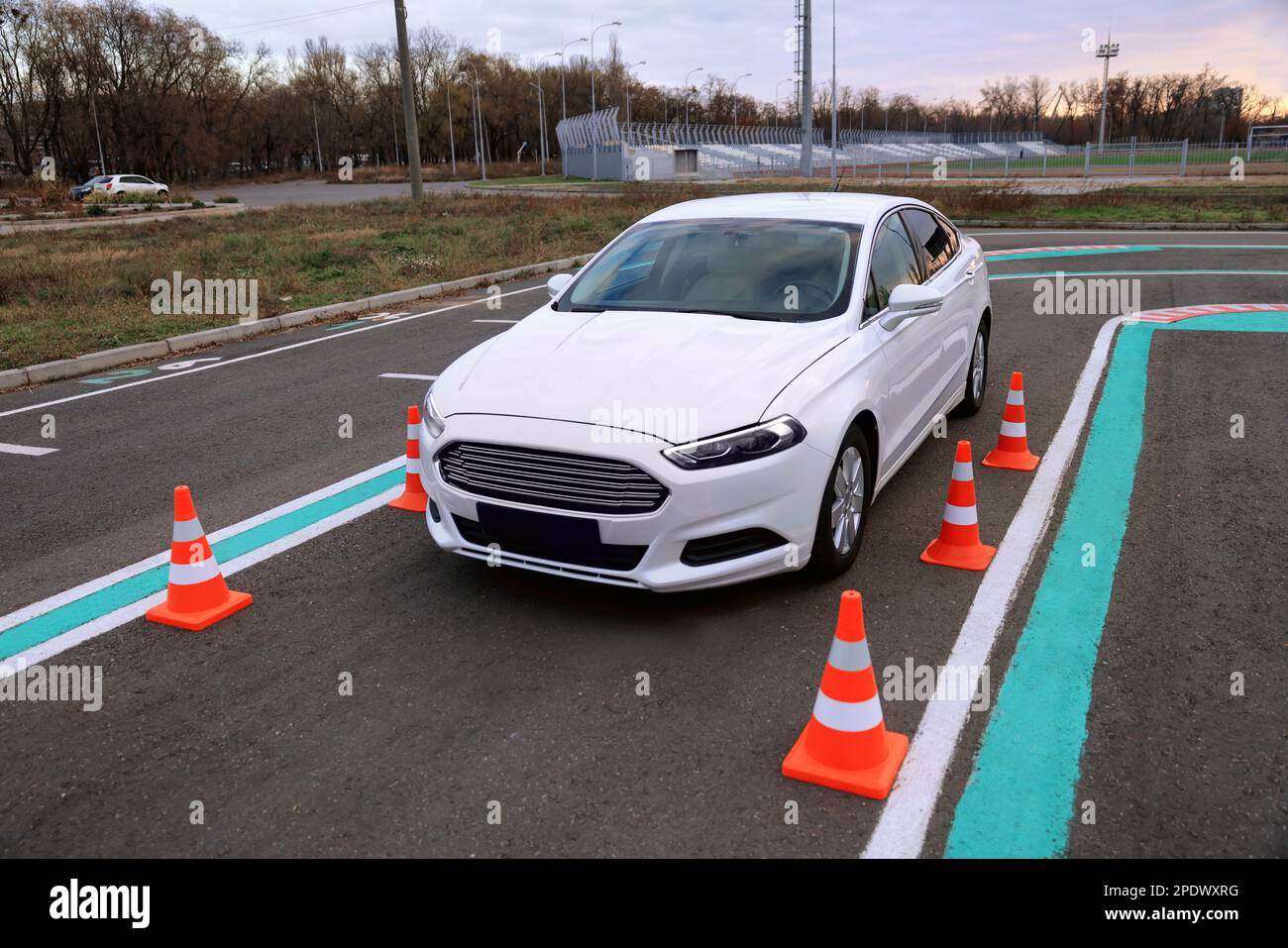 Modern car on driving school test track with traffic cones Stock Photo ...