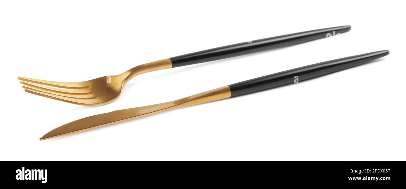 New golden fork and knife with black handles on white background Stock ...