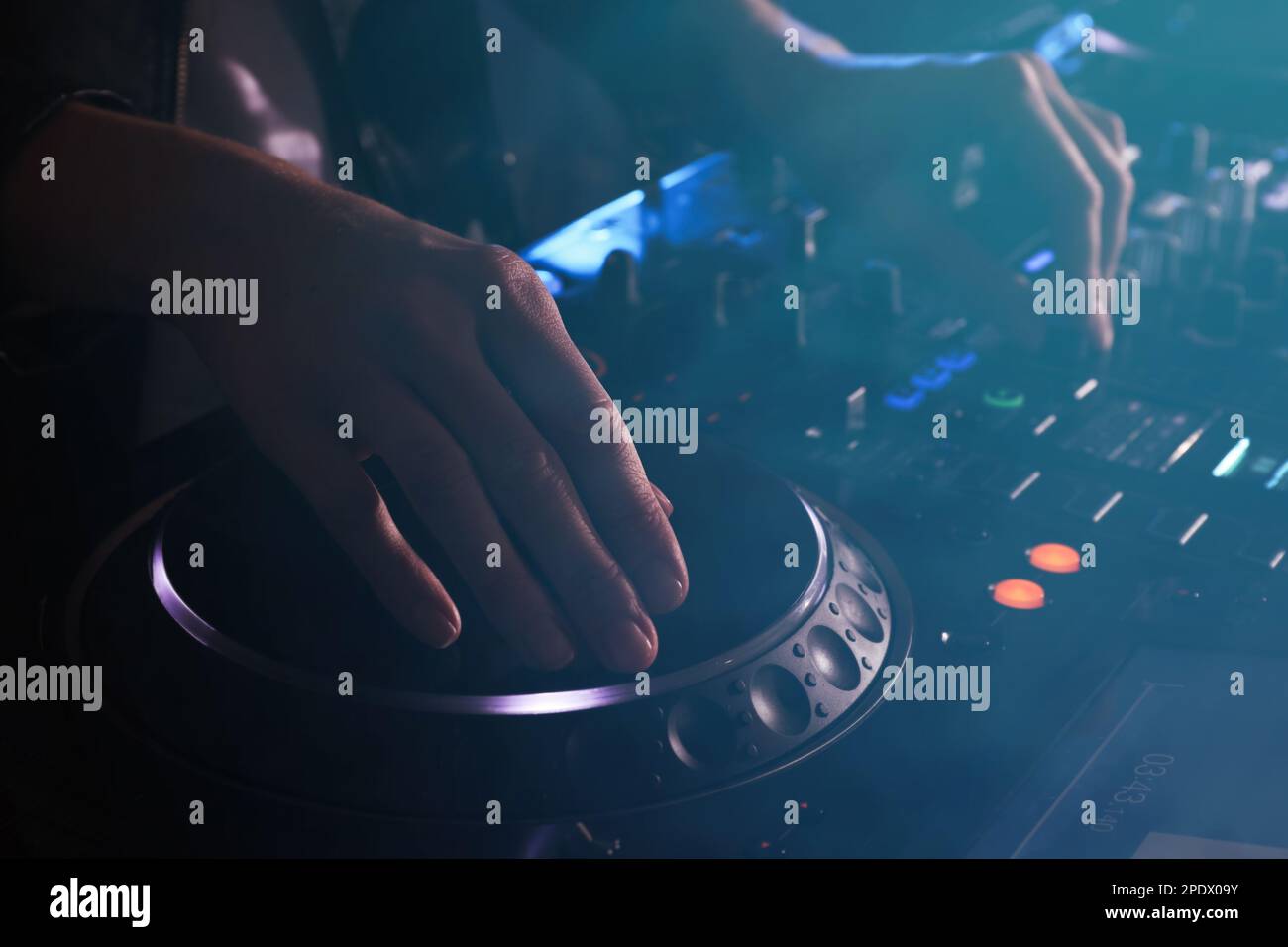 DJ creating music on modern console mixer in night club, closeup Stock ...