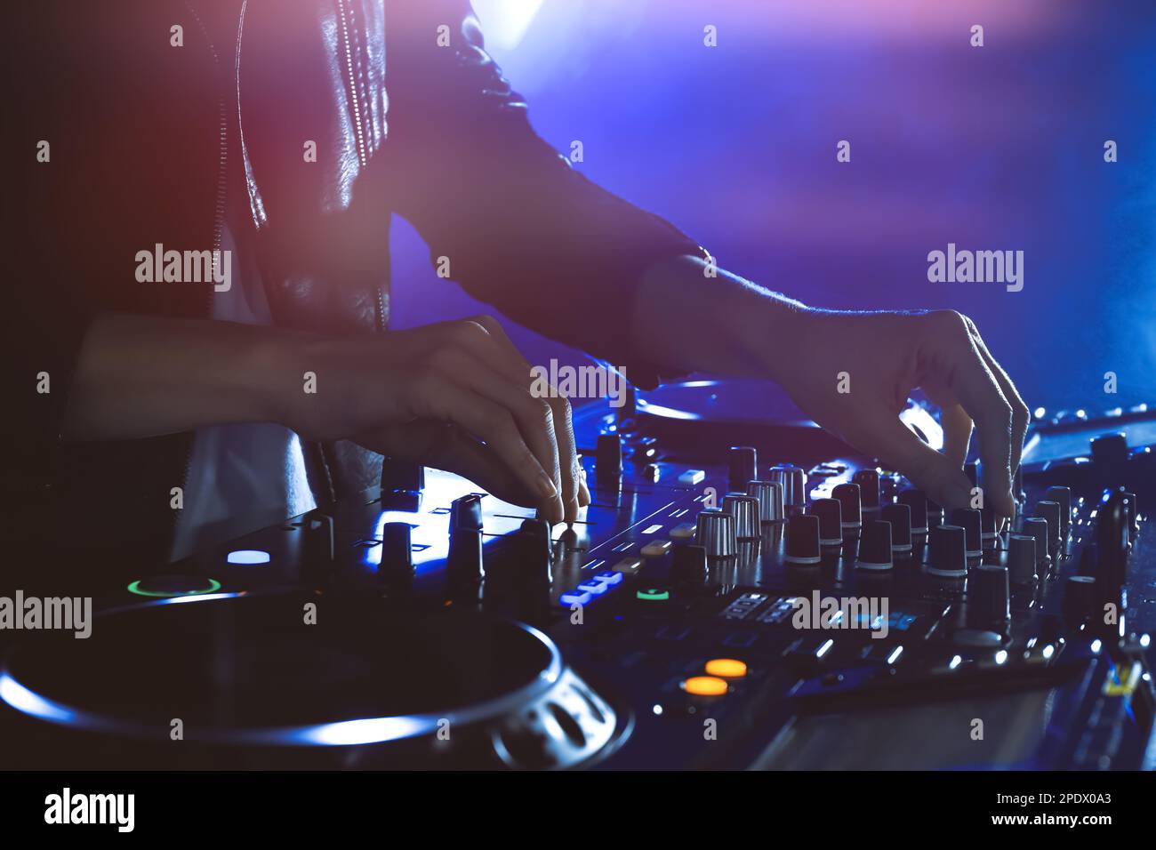 DJ creating music on modern console mixer in night club, closeup Stock ...