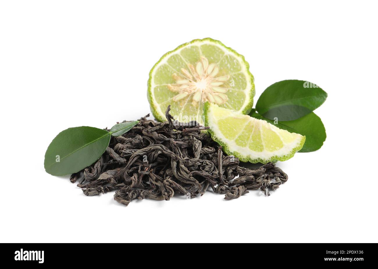 Pile of dry bergamot tea leaves and fresh fruit on white background ...