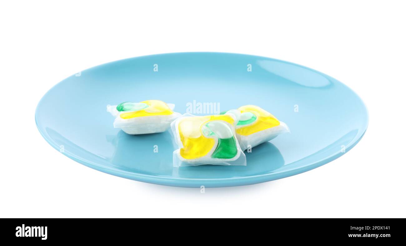 Light blue plate with dishwasher detergent pods on white background ...