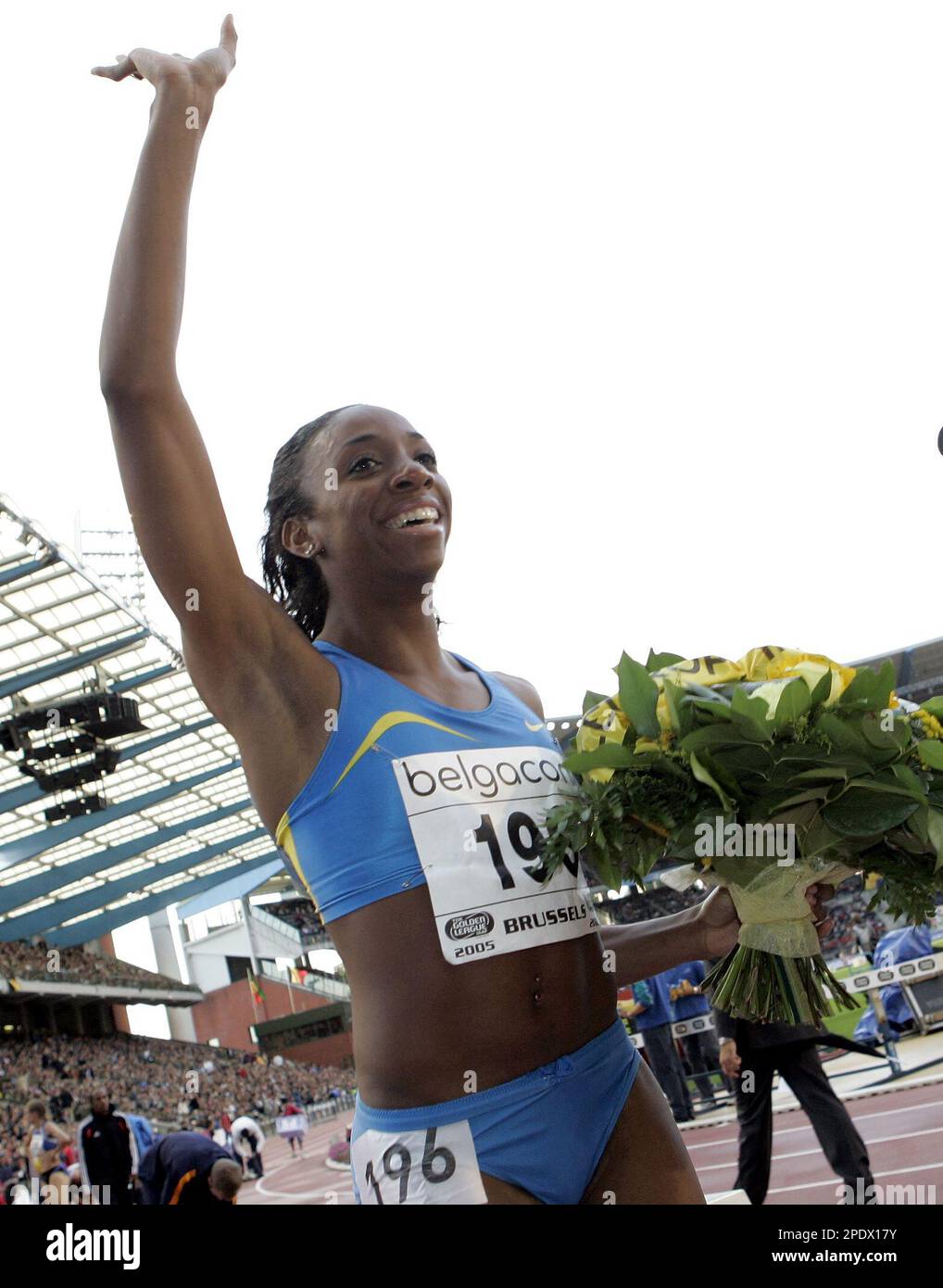 United States, Lashinda Demus holds her flowers and waves to the crowd ...