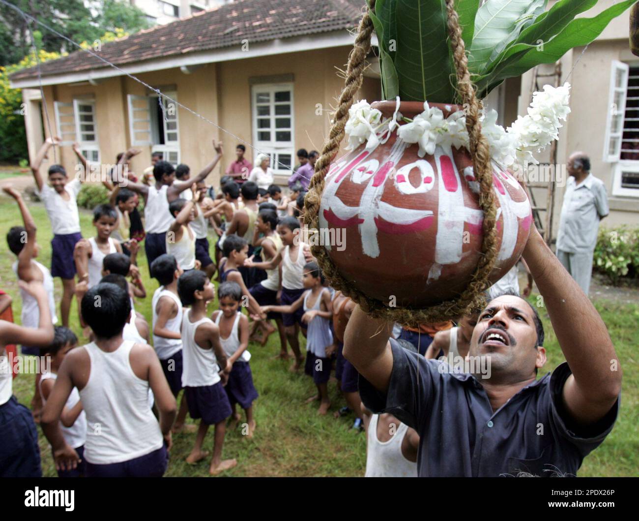 A teacher of the Victoria Memorial Blind School decorate a 'Dahi Handi ...