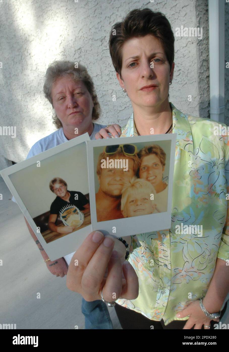 Amanda Humphreys, left, and Daniele Chance-Ferreira, hold up photos of ...