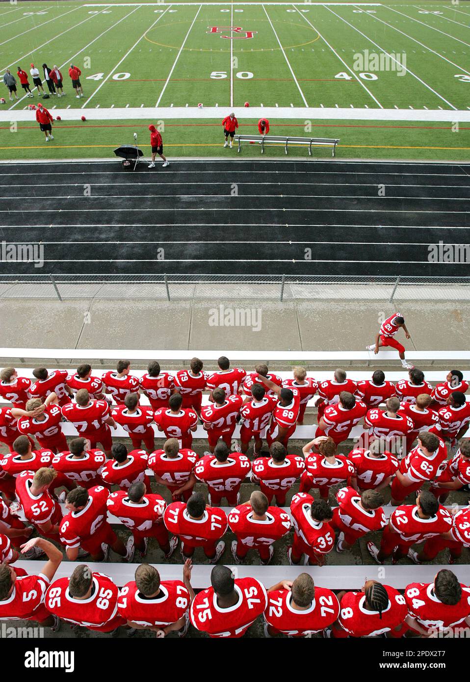 The Regis High School varsity football team gathers on the bleachers as ...