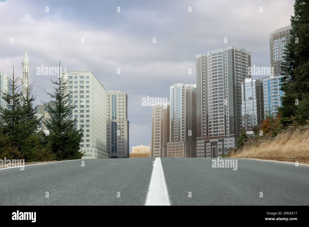 Empty asphalt road and view of cityscape on cloudy say day Stock Photo ...