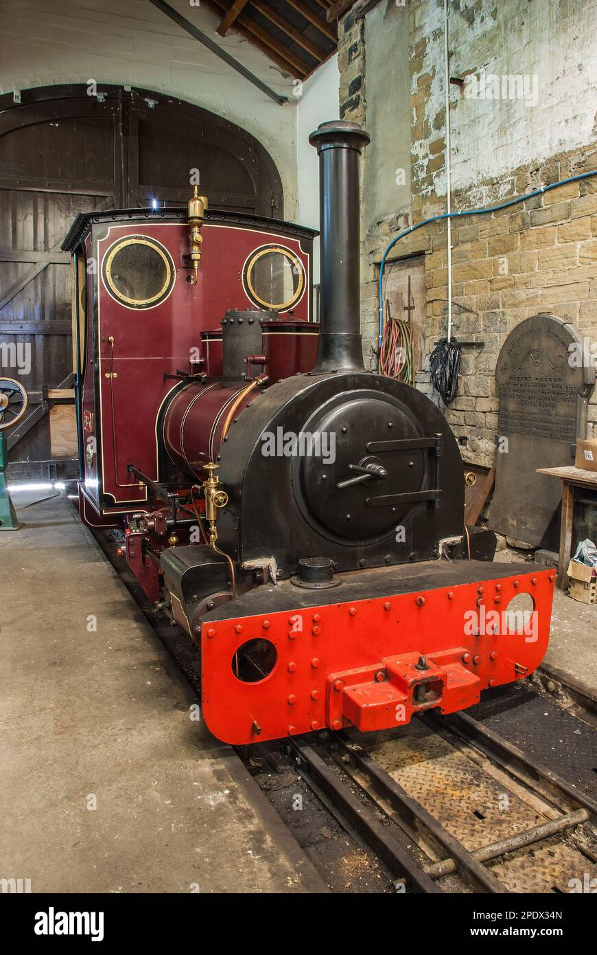 Small preserved steam engine with a tall chimney in a shed at the Leeds ...