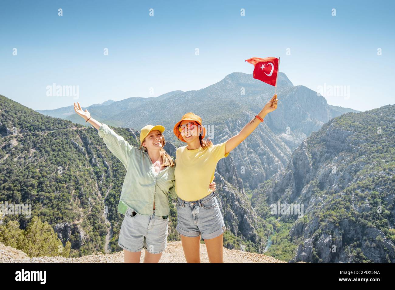 two girls friends take in the stunning mountain scenery together in ...