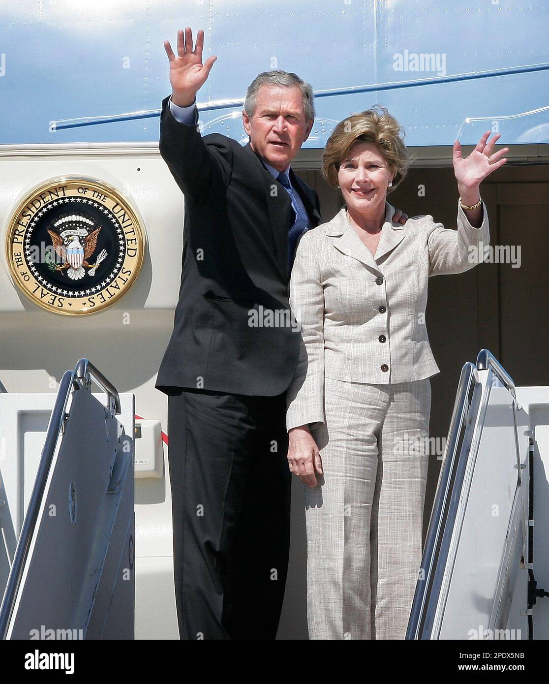 President Bush and first lady Laura Bush wave as they board Air Force ...