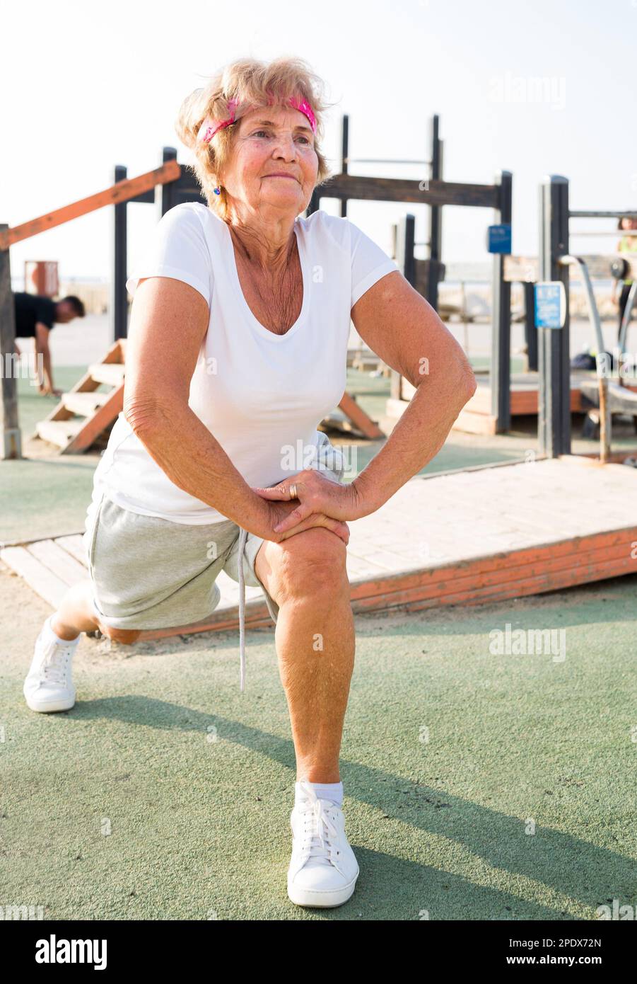 Old woman doing fitness exercises outdoors Stock Photo - Alamy