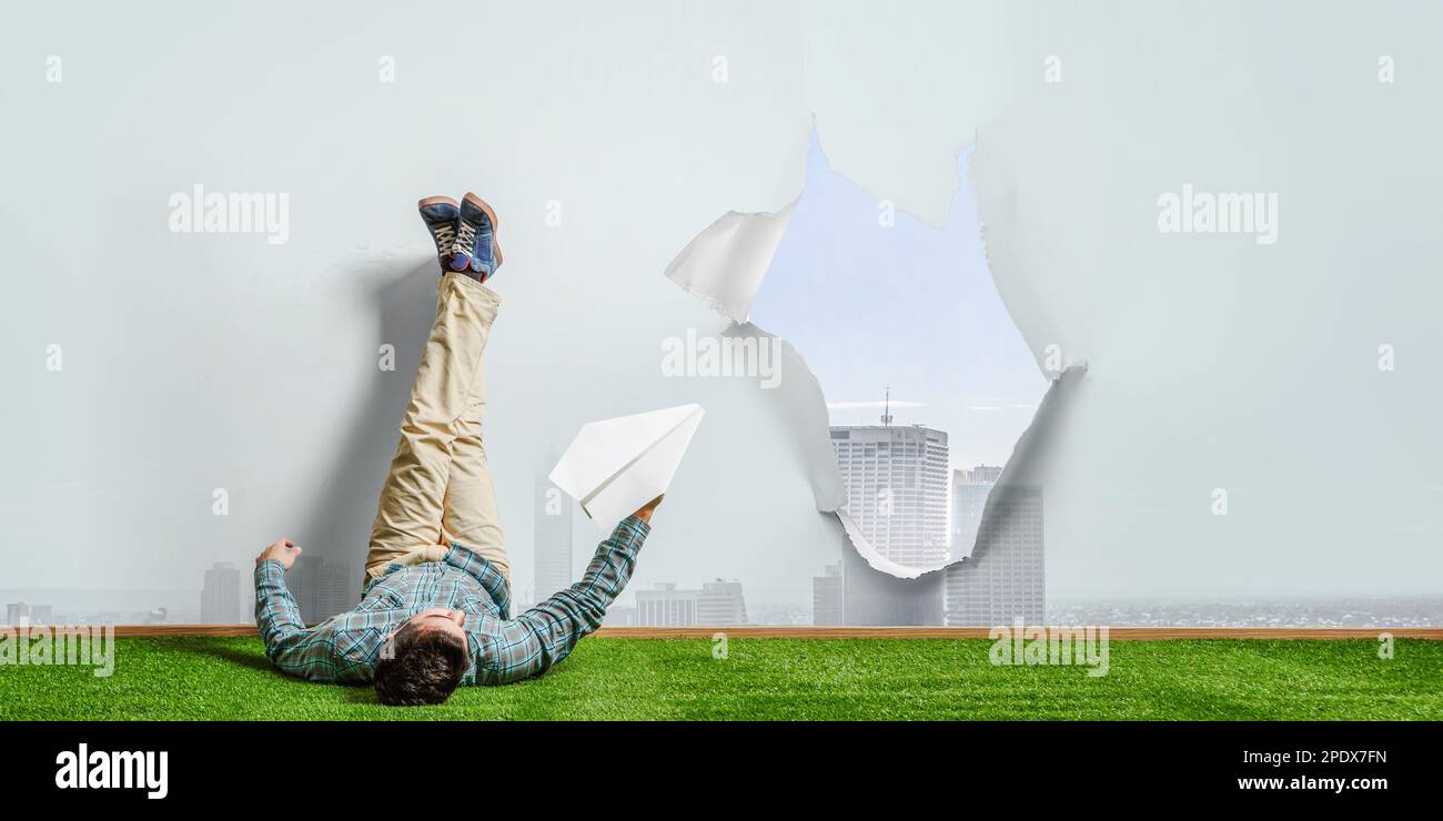Businessman relaxing with his legs up on wall Stock Photo - Alamy
