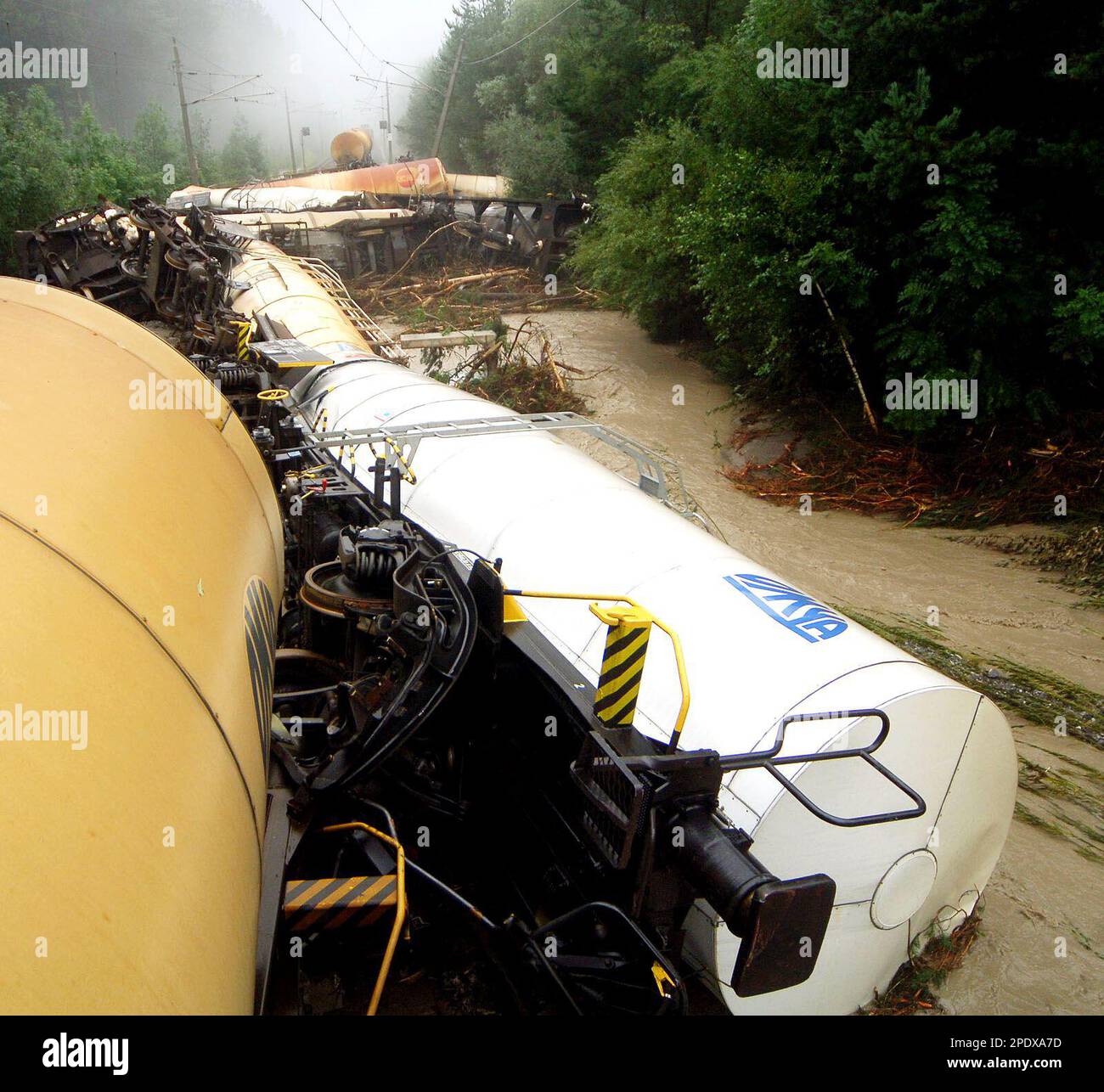 A train lies at the side of the track, derailed by floods near Nenzing ...