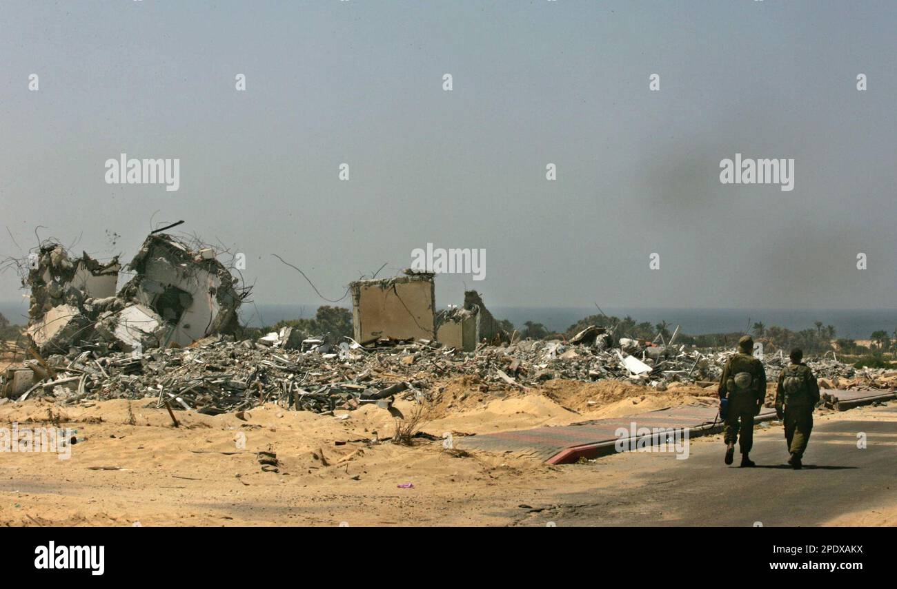 Israeli soldiers patrol next to demolished houses in the evacuated ...