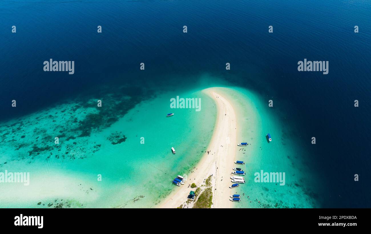 Aerial drone of beautiful Sibuan island with a beach and a coral atoll ...