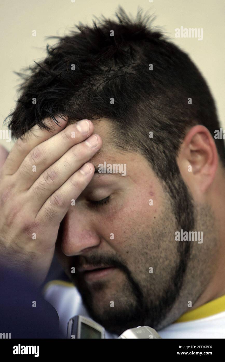 San Francisco 49ers offensive lineman Justin Smiley holds his head as ...