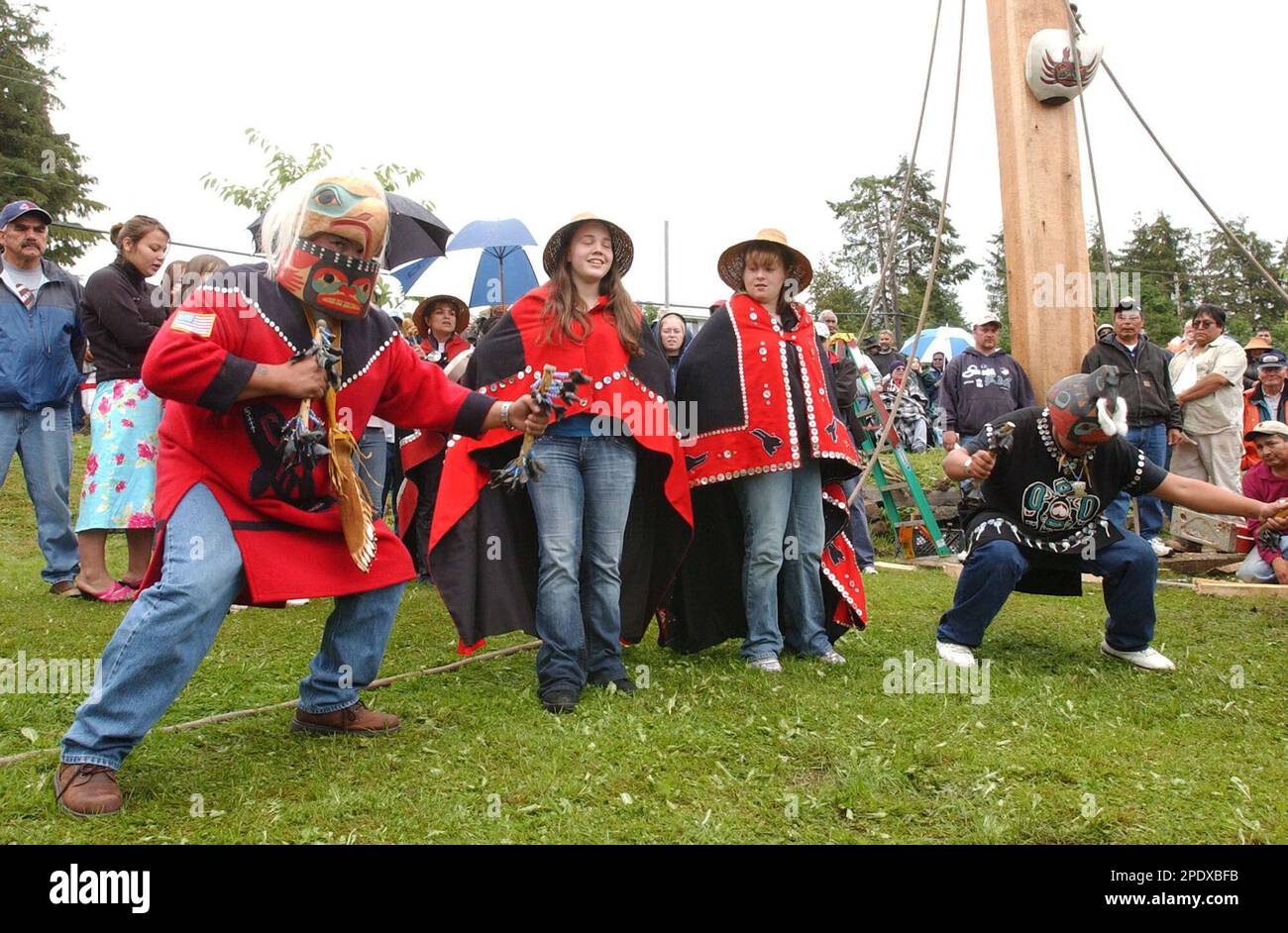 Totem pole carver Jon Rowan, far left, does his carver's dance with his ...
