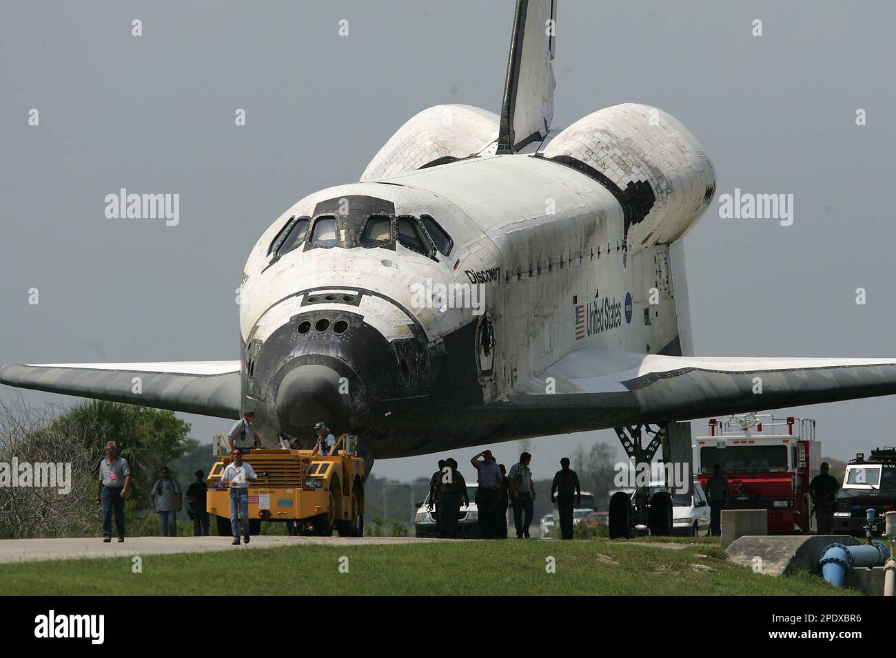 The space shuttle Discovery is towed from the mate-demate device to the ...