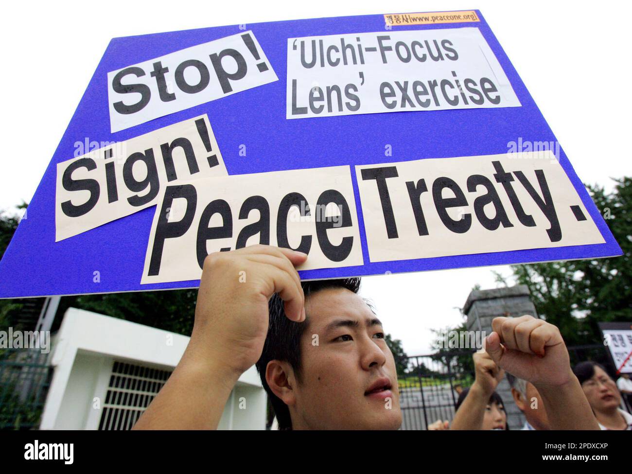 A South Korean protester clenches a fist during a rally against South ...