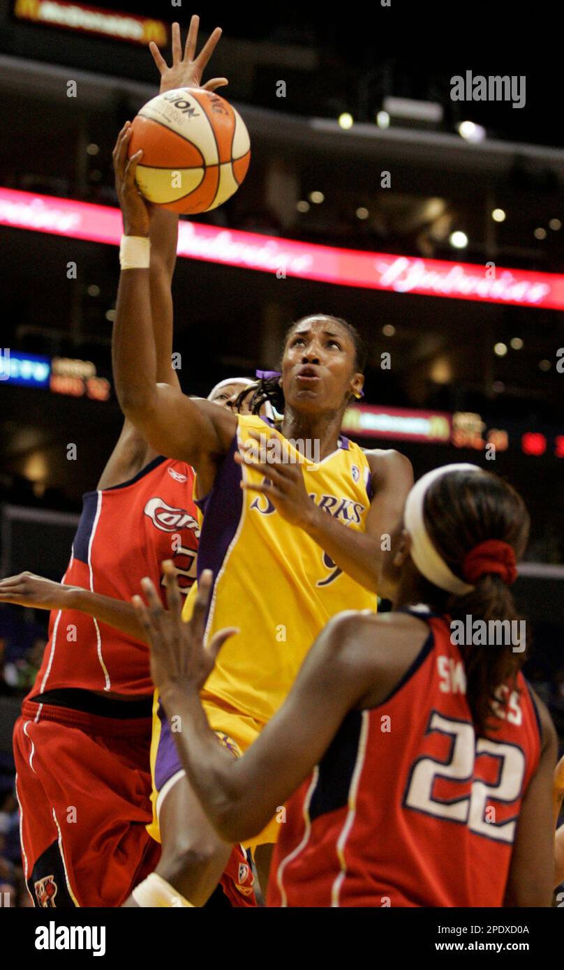 Los Angeles Sparks' Lisa Leslie shoots over Houston Comets' Sheryl ...