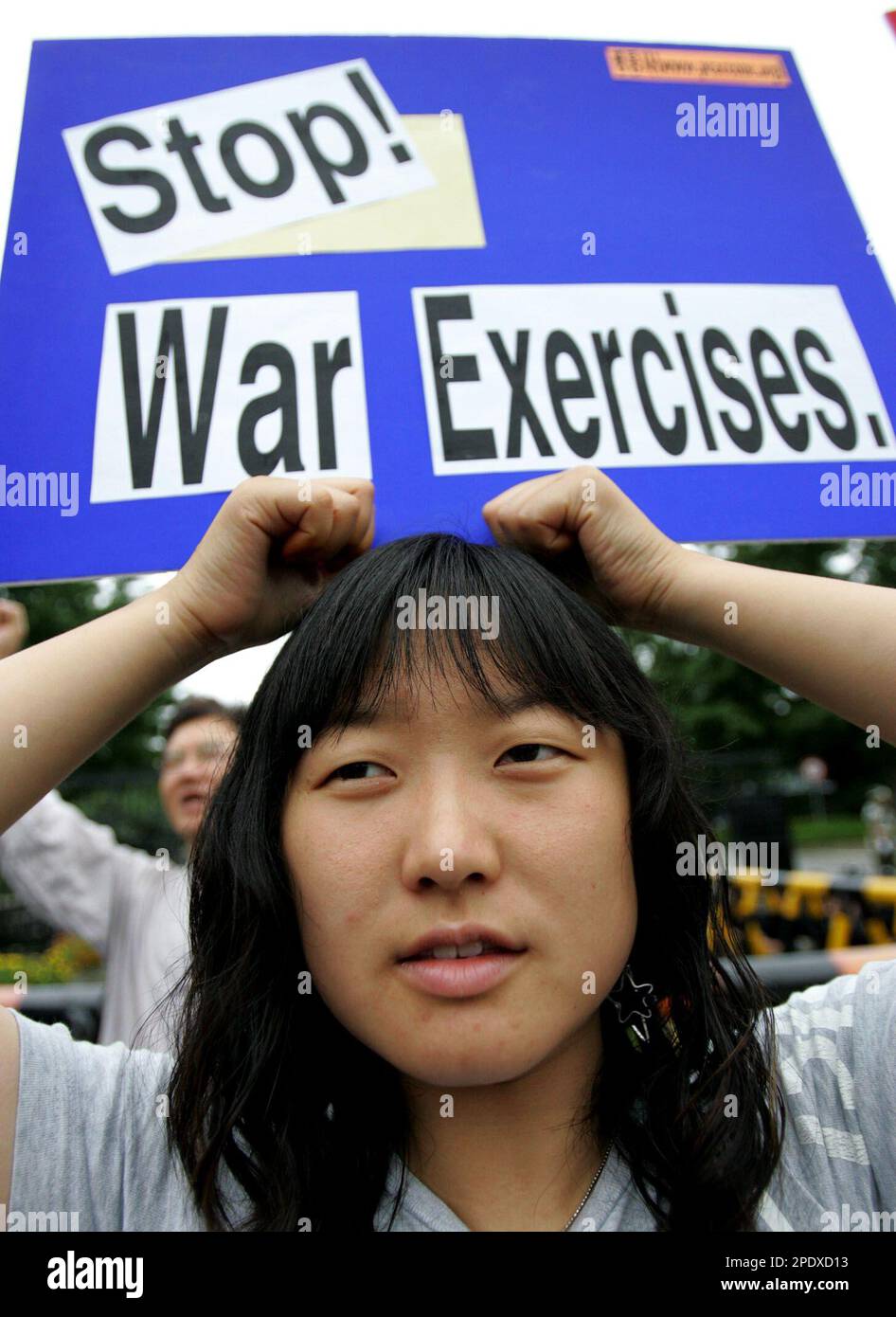 A South Korean protester flashes a campaign placard during a rally ...