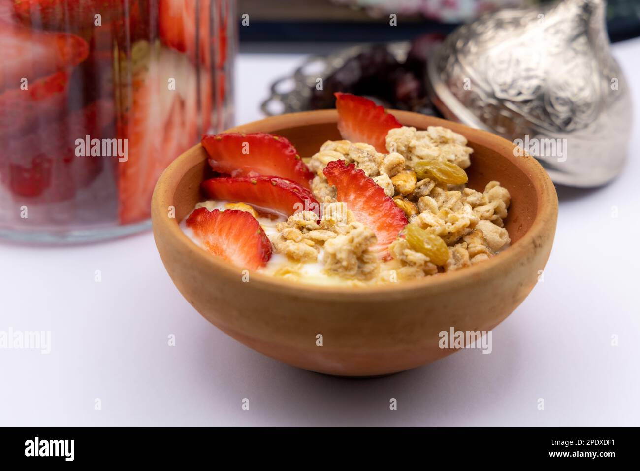 Healthy Breakfast - Cereals Oats, Strawberry, honey with Yogurt nuts in the clay bowl Stock ...