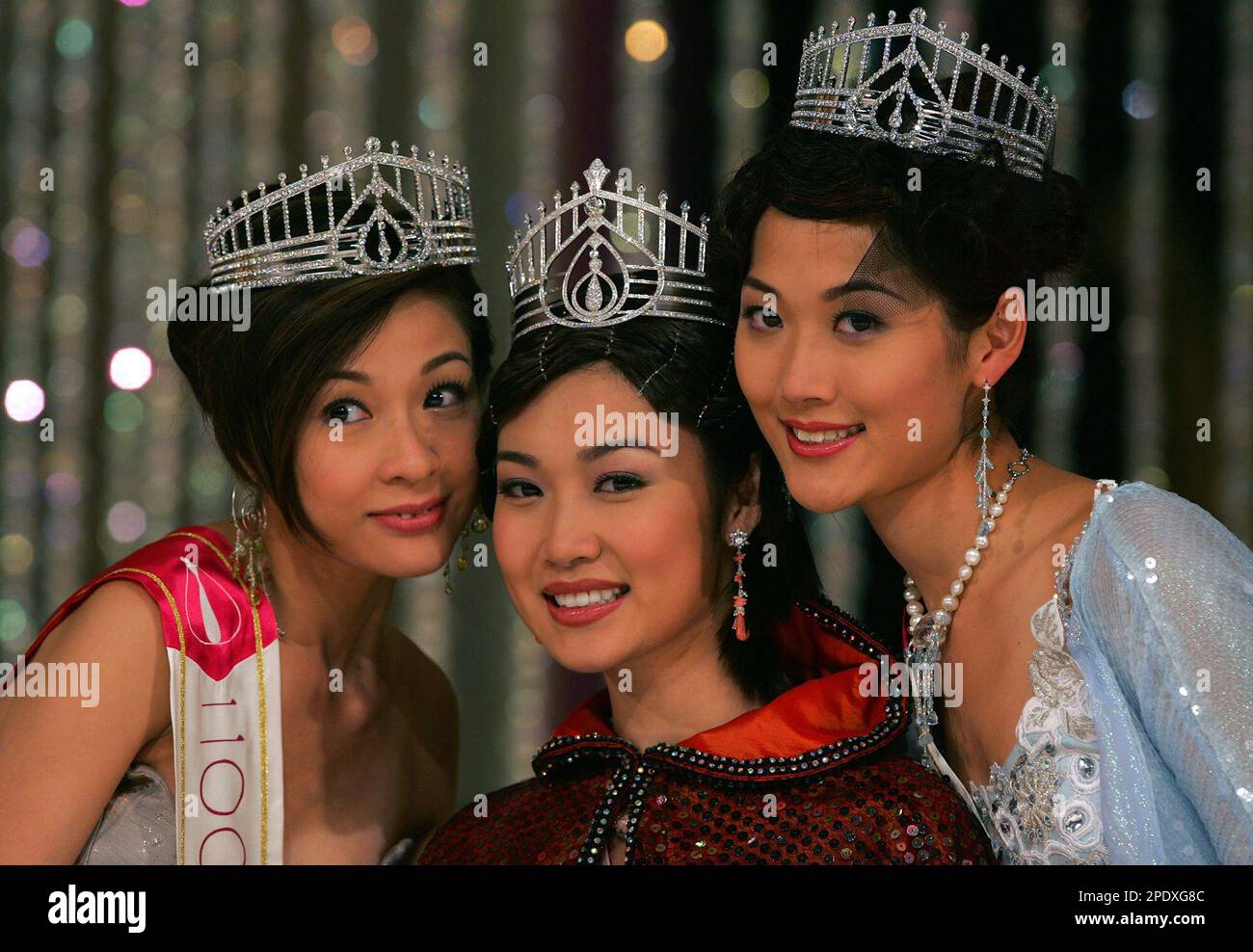 Miss Hong Kong winner Tracy Ip Chui Chui, center, poses with first runner-up Sharon Luk Sze Wan ...