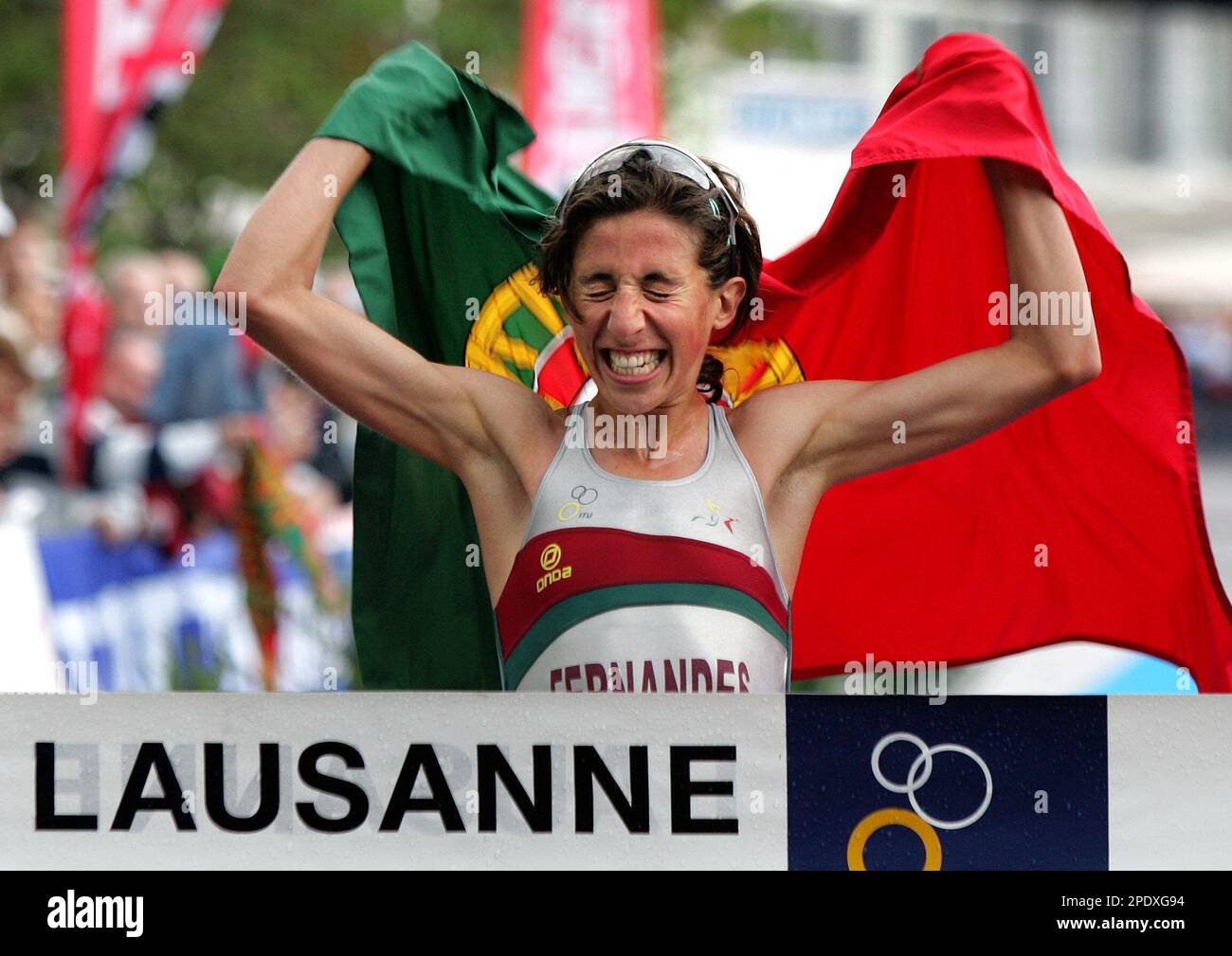 Portugal's Vanessa Fernandes react as she crosses the finishing line to ...