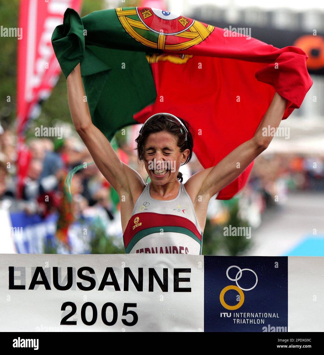 Portugal's Vanessa Fernandes react as she crosses the finishing line to ...