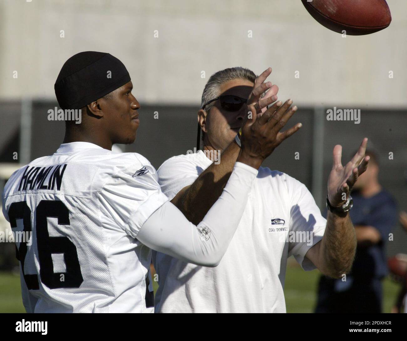 Seattle Seahawks free safety Ken Hamlin, left, playfully knocks away a ...