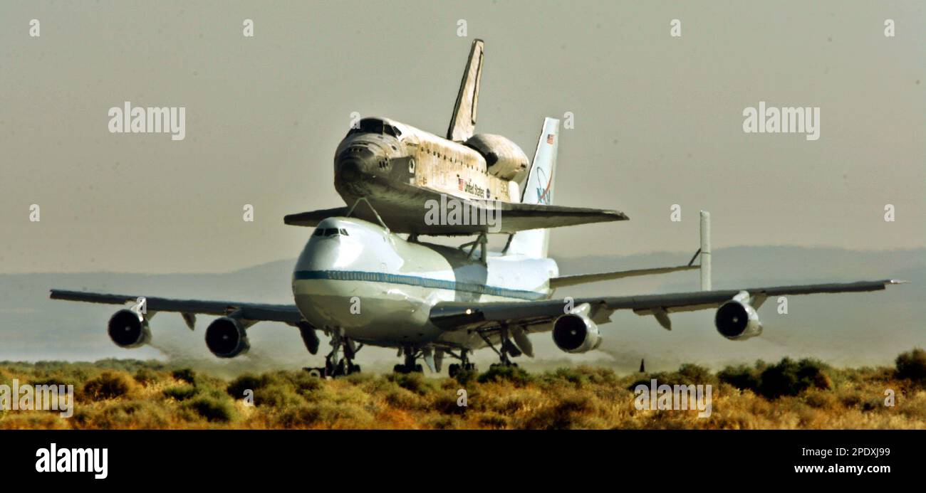 The Space Shuttle Discovery, mounted atop a NASA 747, begins its roll ...