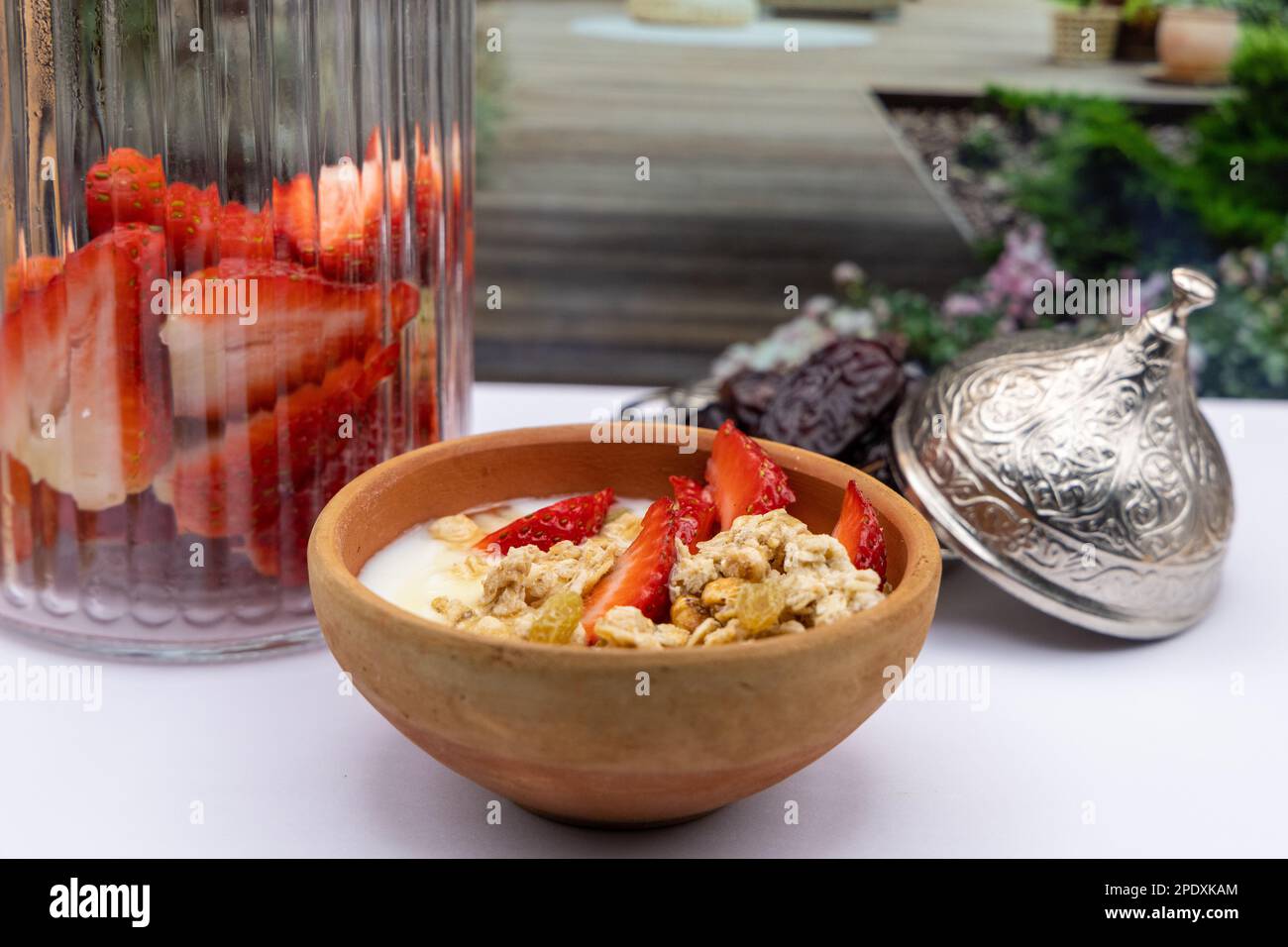 Healthy Breakfast - Cereals Oats, Strawberry, honey with Yogurt nuts in the clay bowl Stock ...