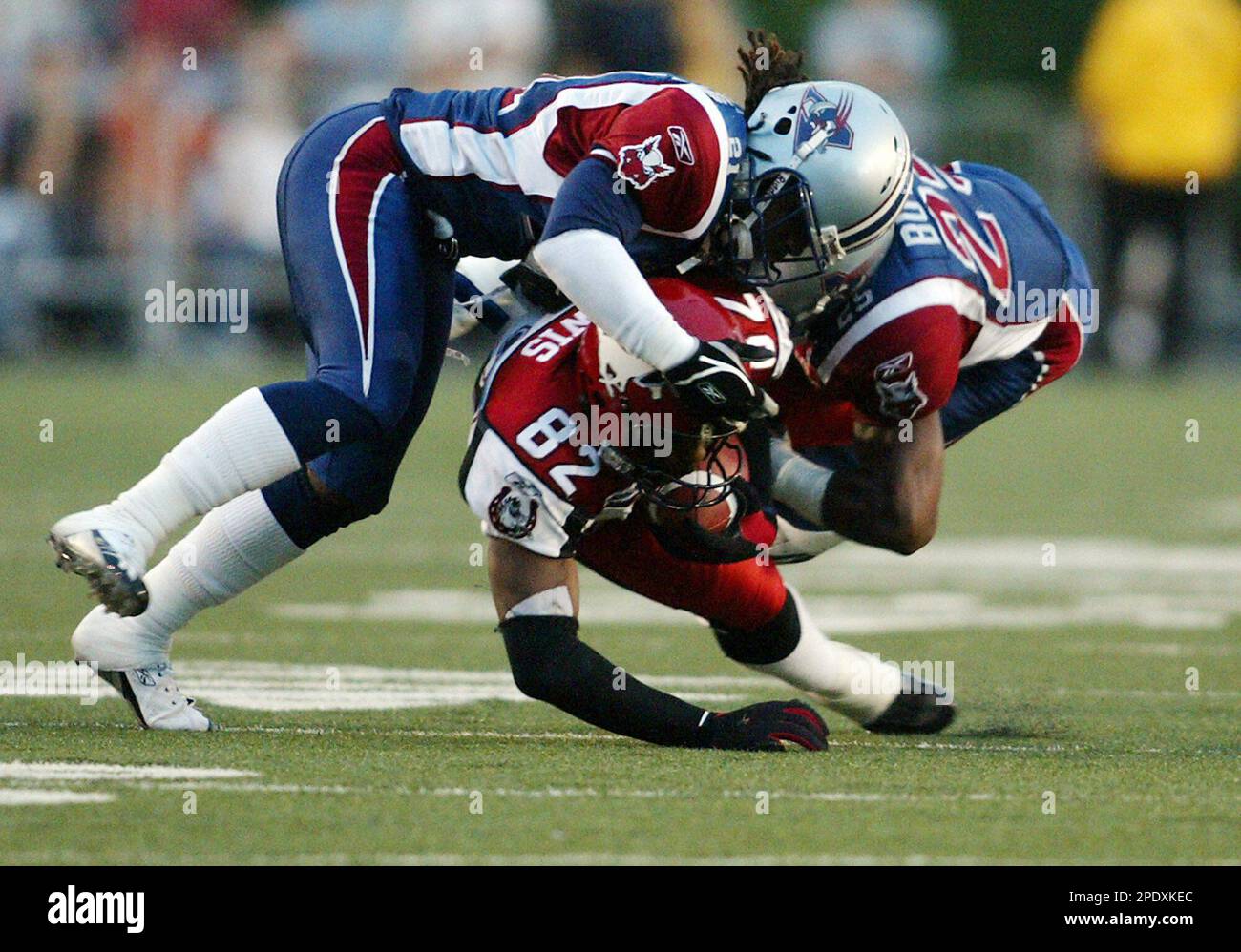 Montreal Alouettes' Kelly Malveaux, left, and Duane Butler tackle ...