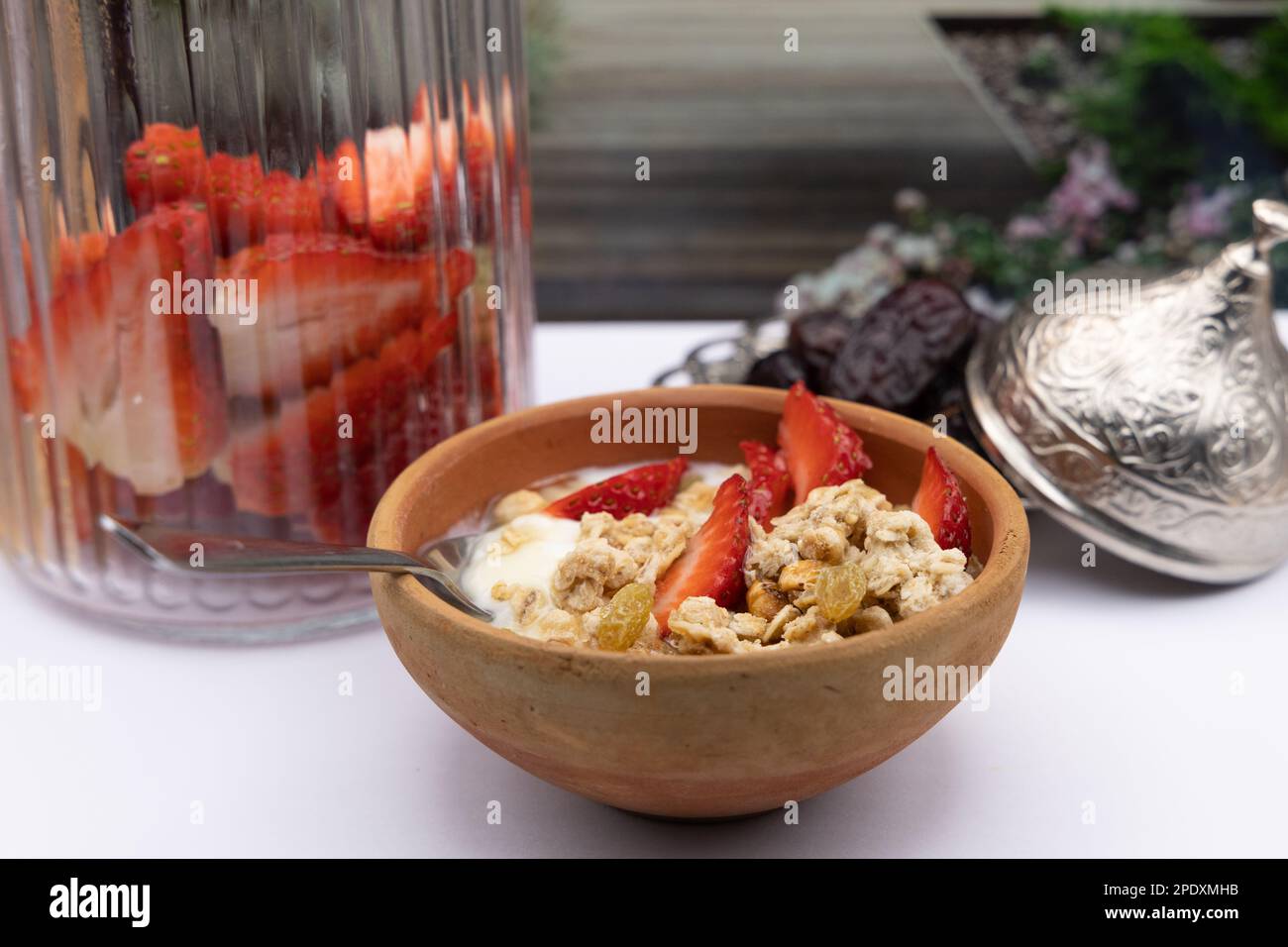 Healthy Breakfast - Cereals Oats, Strawberry, honey with Yogurt nuts in the clay bowl Stock ...