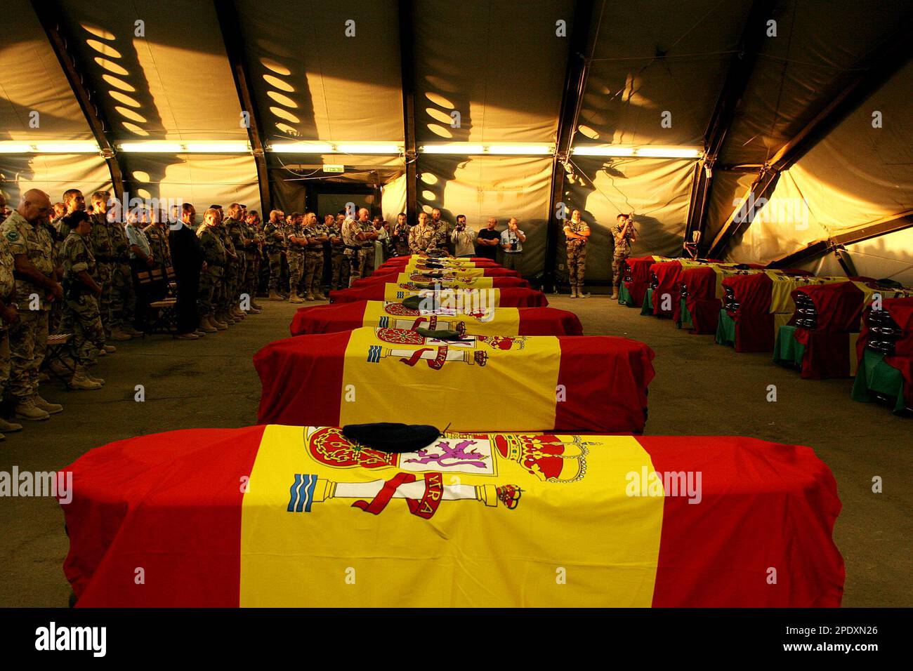 Spanish soldiers attend a mass in front of the coffins of 17 soldiers ...