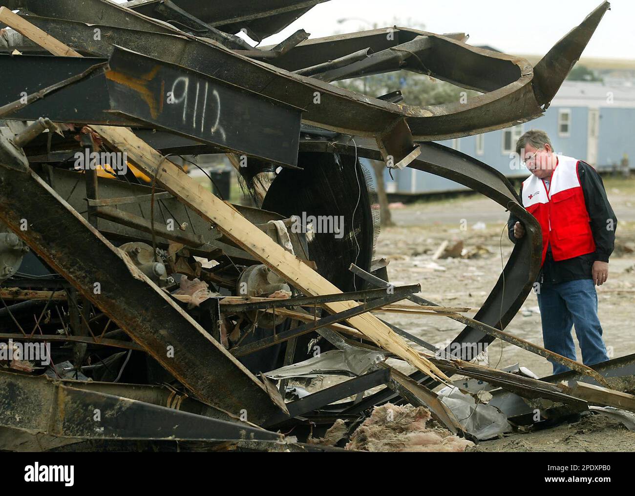 Wyoming Gov. Dave Freudenthal looks at a pile of twisted trailer house ...