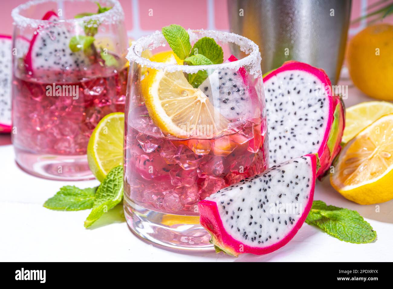 Sweet colorful tropical cocktail with pitaya or dragon fruit, lime and ...